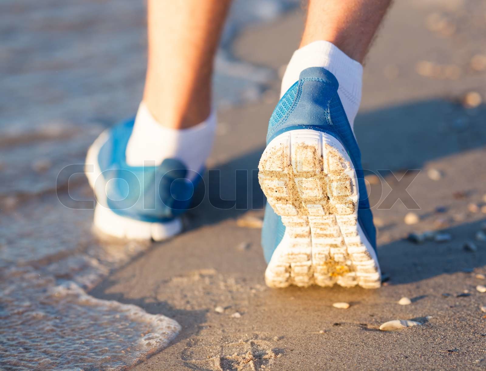 Athlete running in the sand feet | Stock image | Colourbox