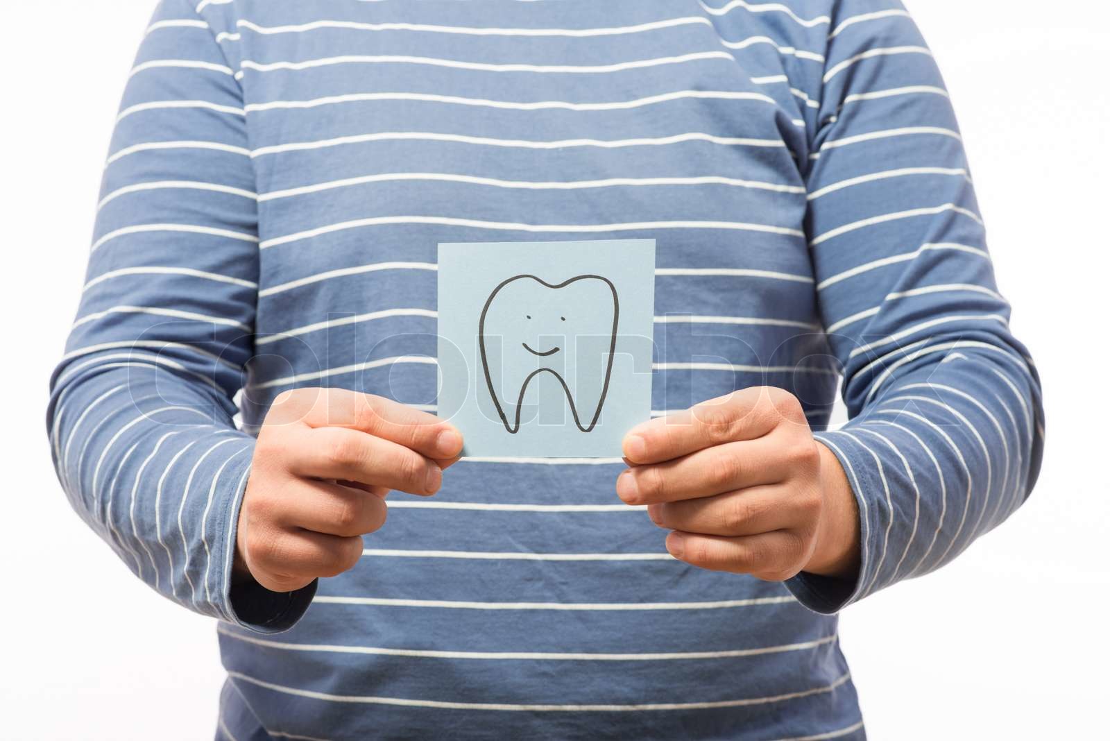 drawing a picture in his hand tooth | Stock image | Colourbox