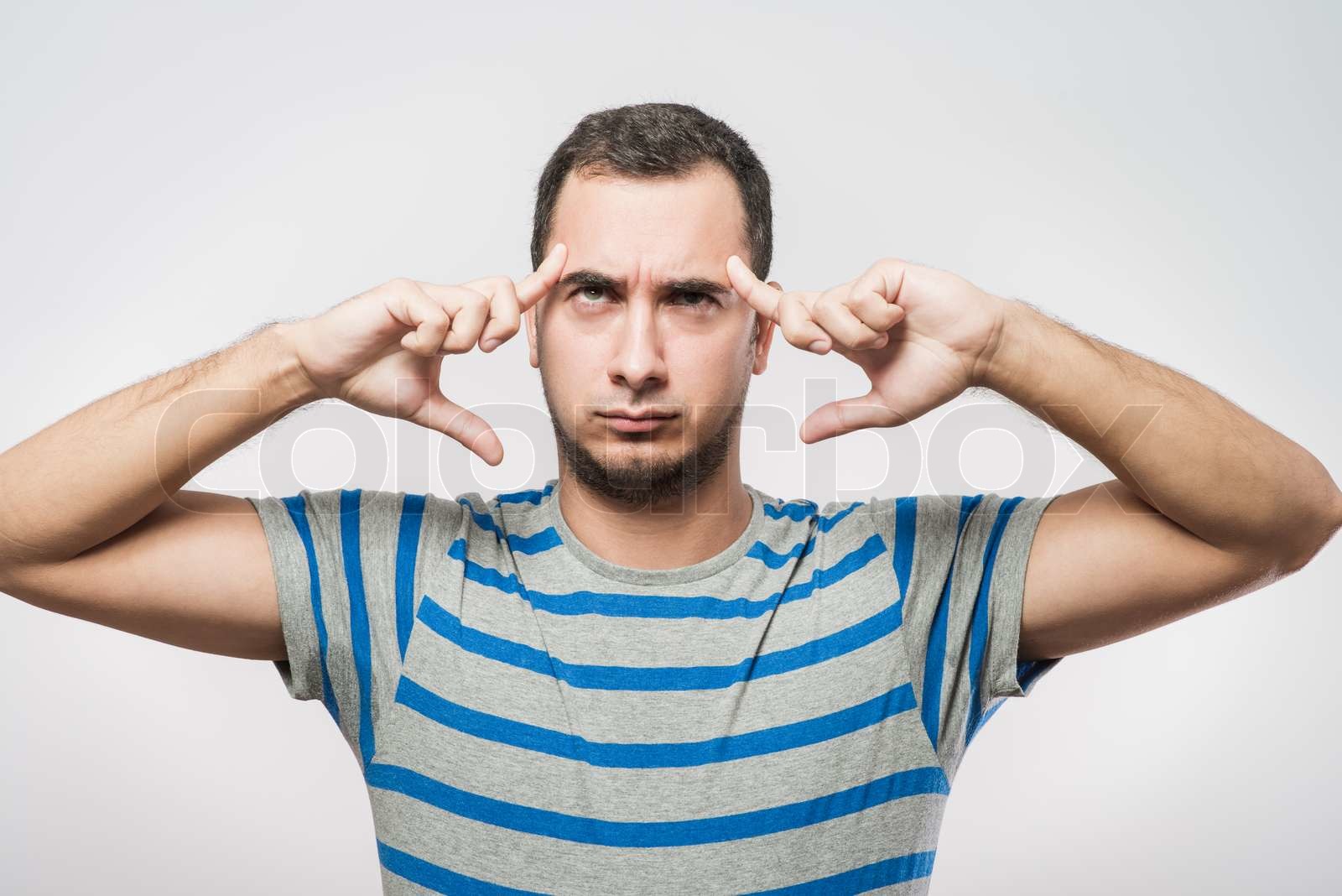 Man covering his hears | Stock image | Colourbox
