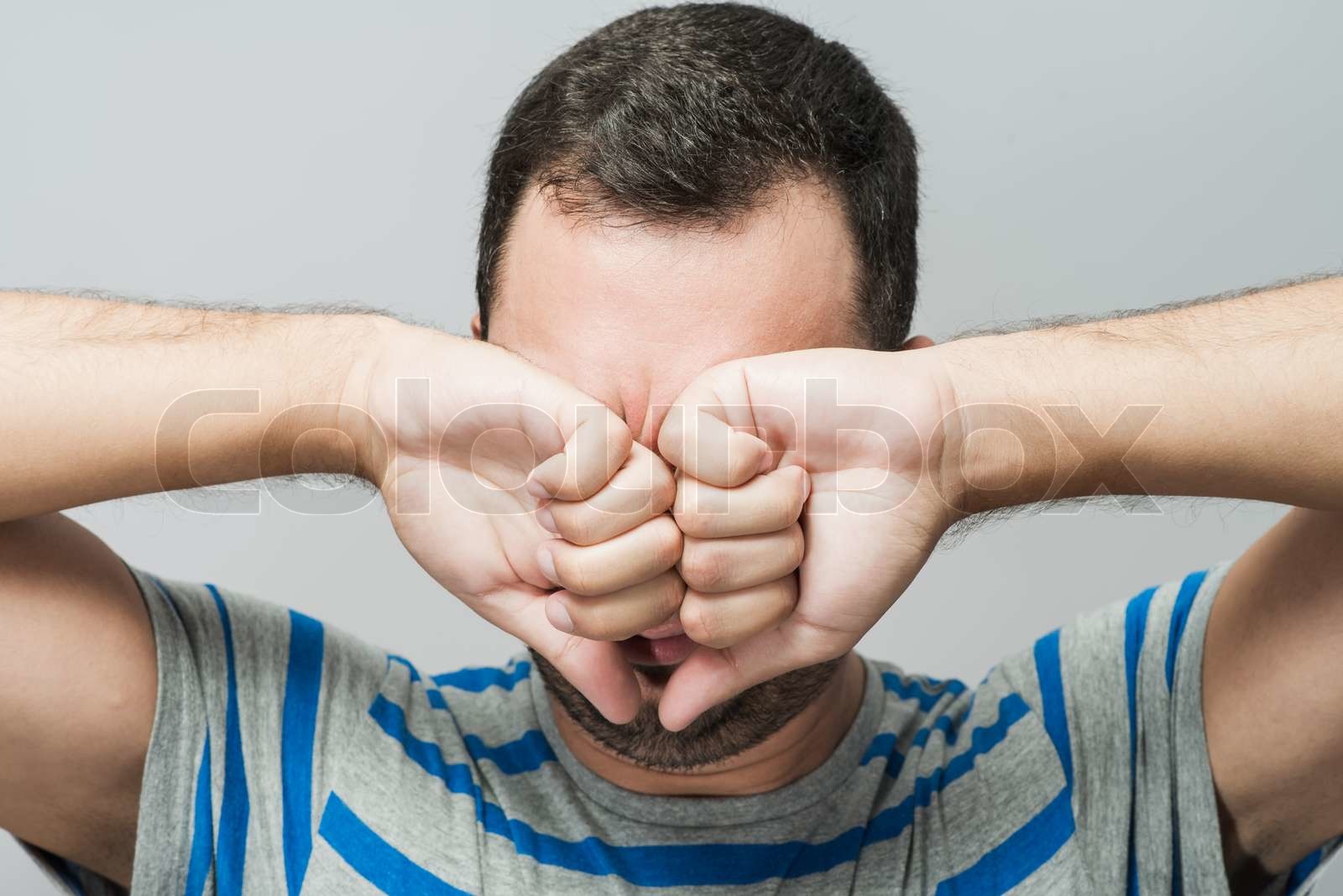 Man covering his hears | Stock image | Colourbox