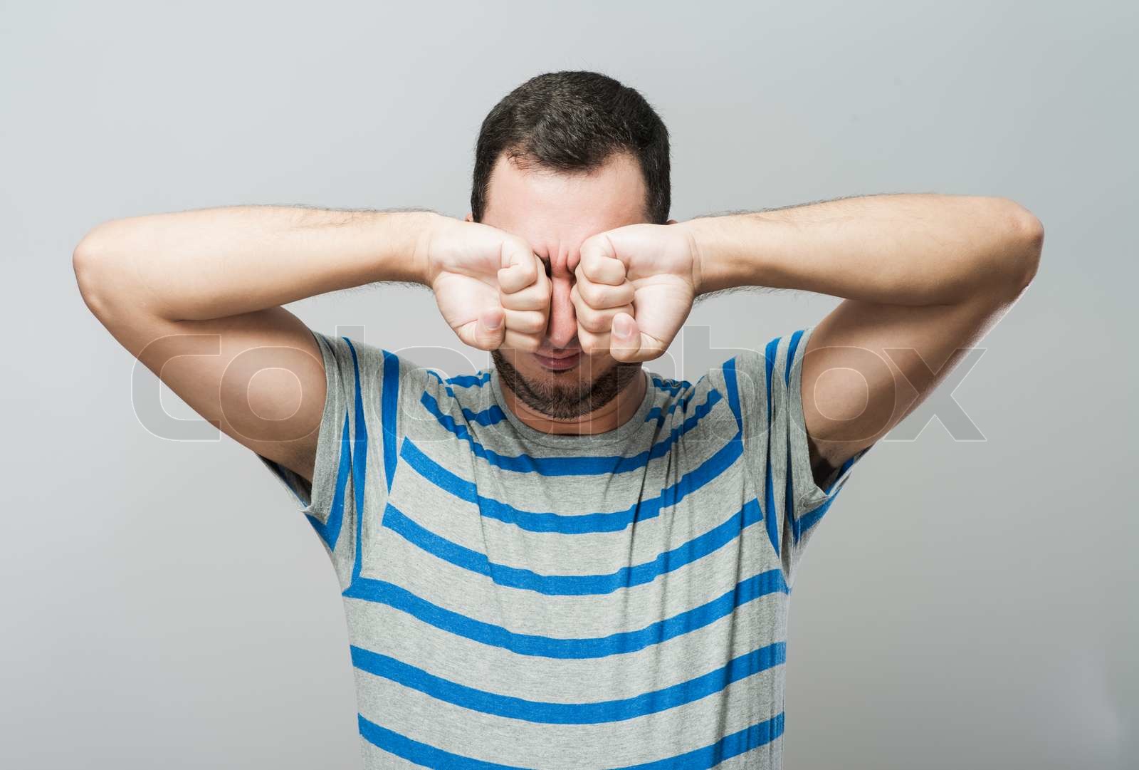 Man covering his hears | Stock image | Colourbox