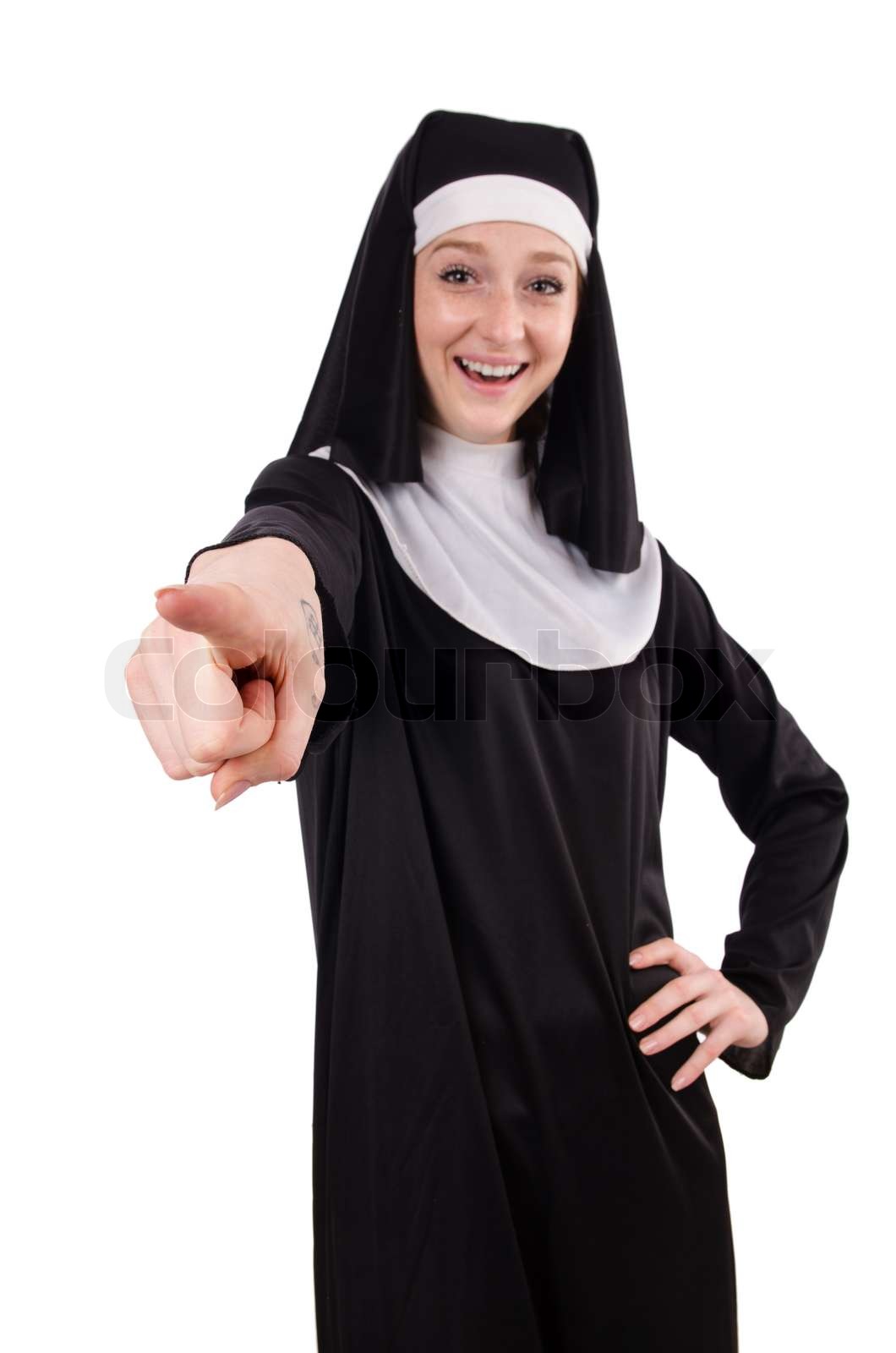 Young smiling nun pointing isolated on white | Stock image | Colourbox