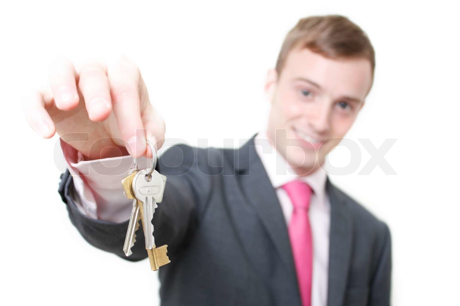 A business man giving you the keys to a home | Stock image | Colourbox