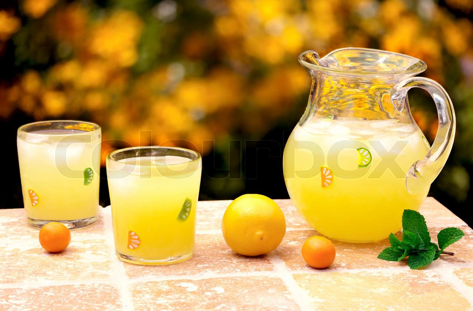 Fresh Squeezed Lemonade On Table With Colorful Orange and Green ...