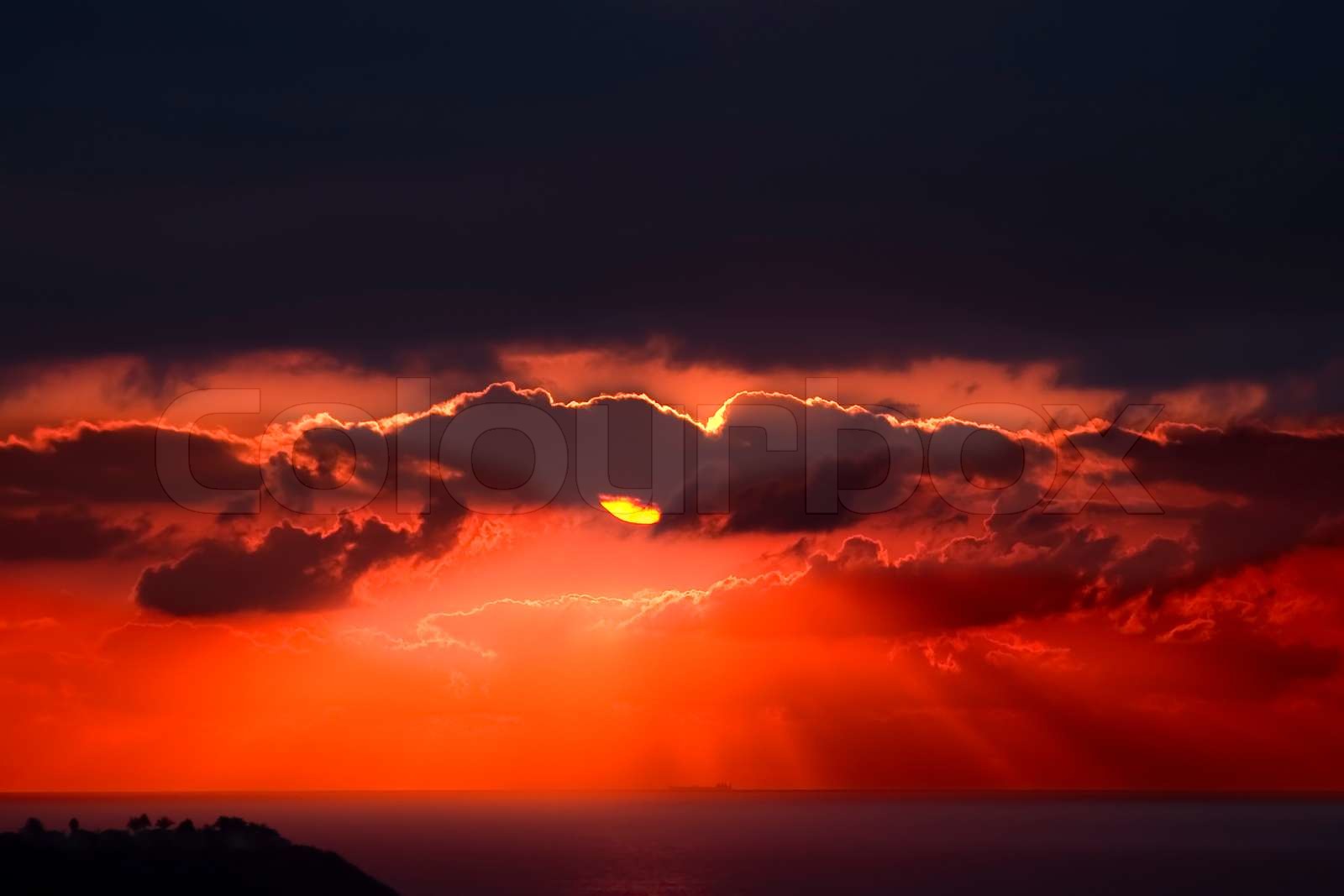 Ruby Sunset Over Ocean ~ Sun Beams | Stock image | Colourbox