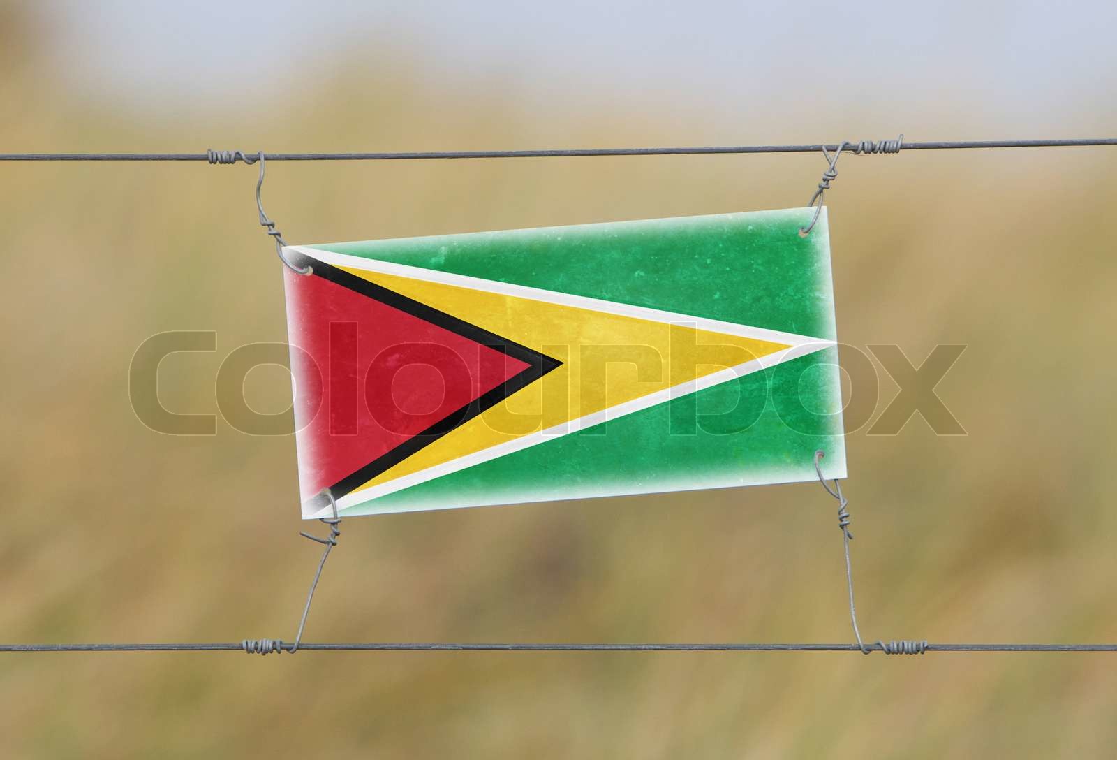 Border fence - Old plastic sign with a flag | Stock image | Colourbox
