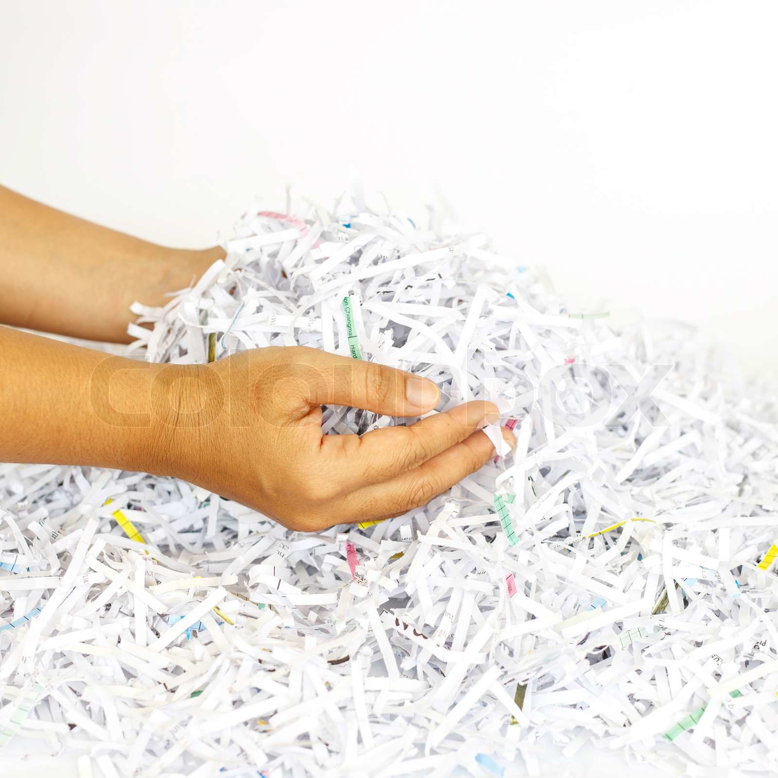 Hand holding Scrap Paper from paper cutter | Stock image | Colourbox