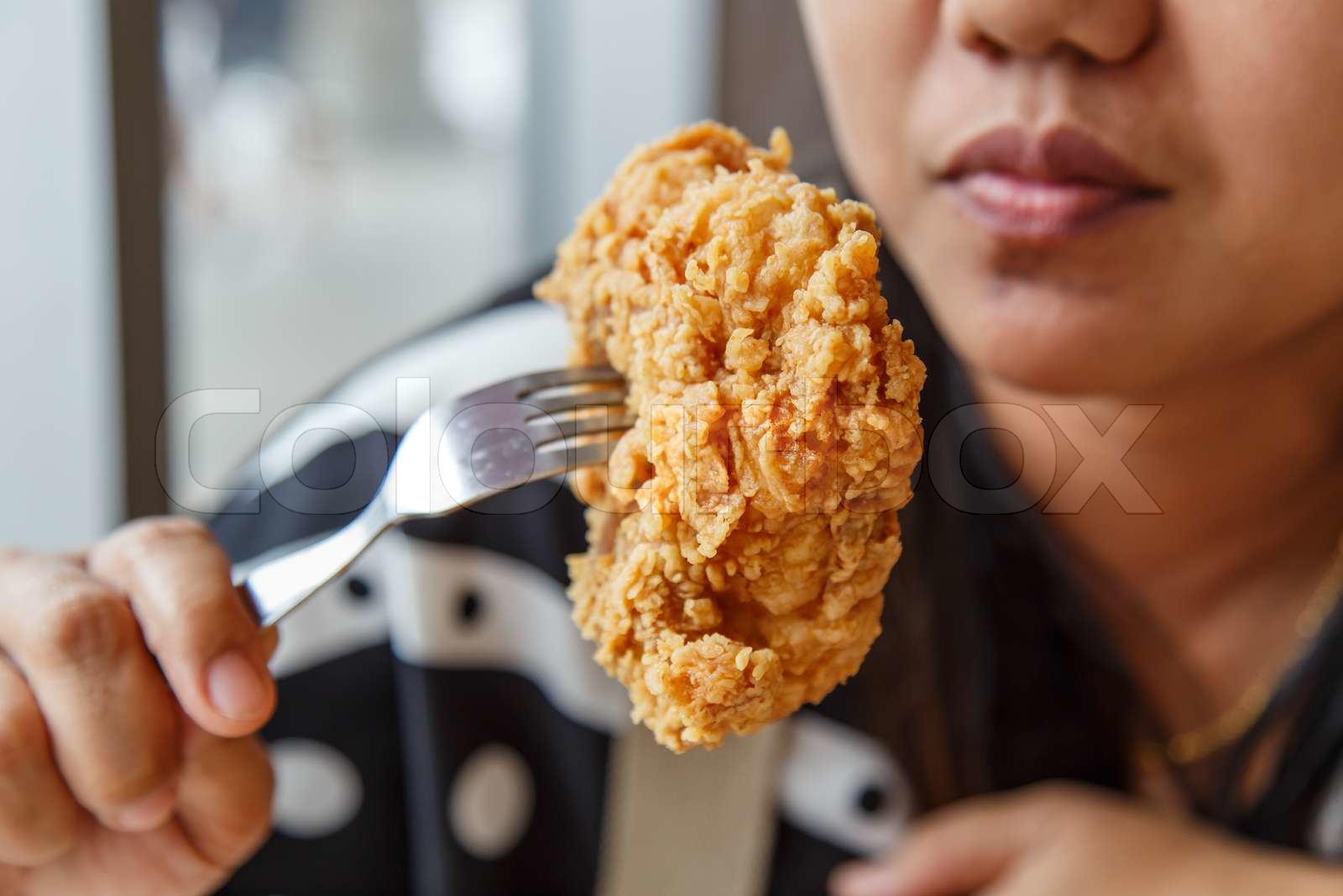 Hand holding Fried chicken and eating in the restaurant | Stock image ...