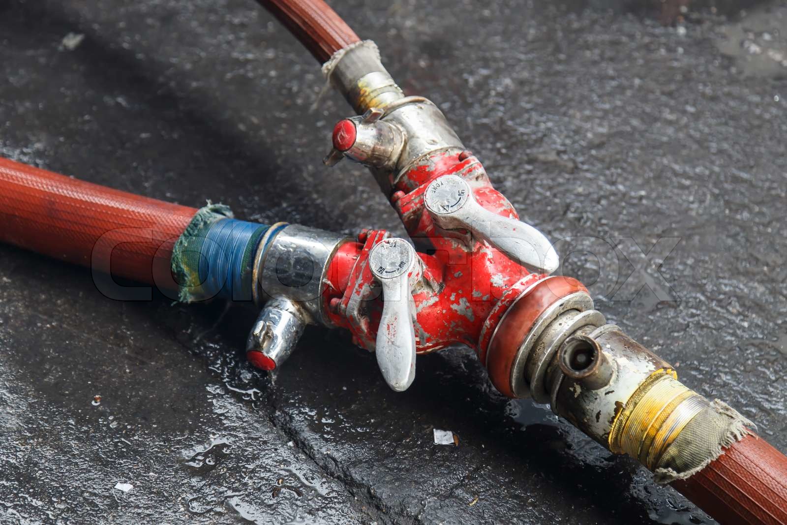 Fire Water hose connector on the ground | Stock image | Colourbox