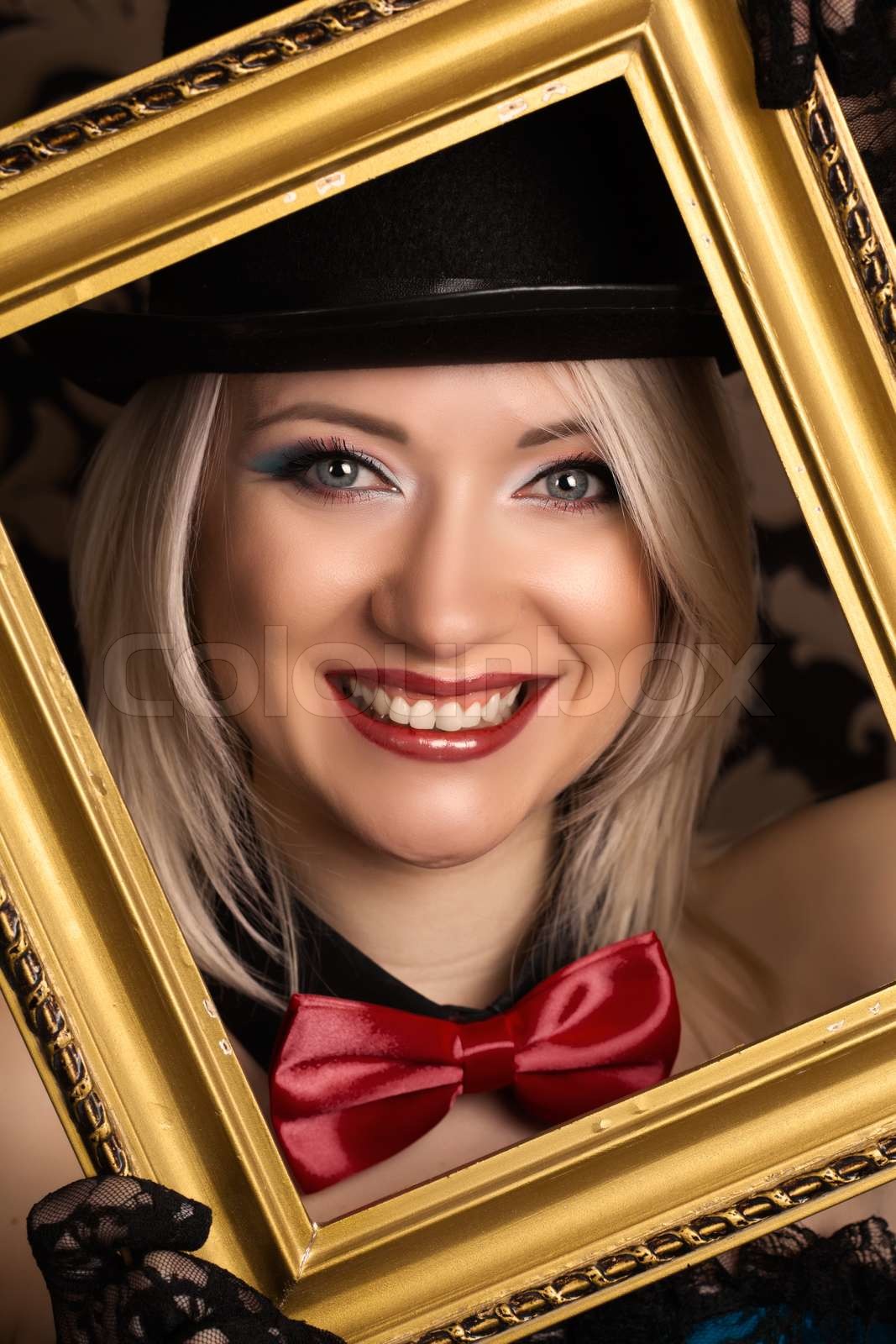 beautiful cabaret woman posing with golden frame against retro ...
