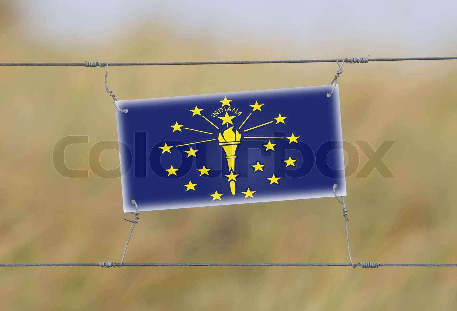 Border fence - Old plastic sign with a flag | Stock image | Colourbox