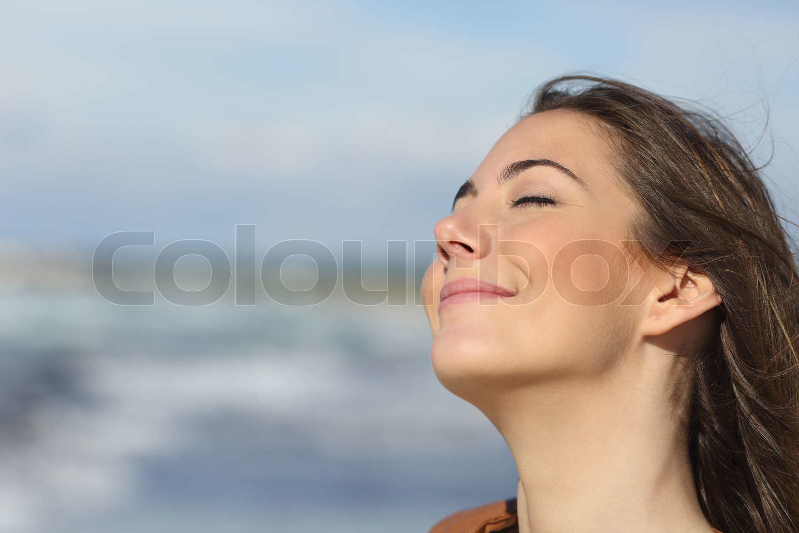 Closeup of a woman breathing fresh air on the beach | Stock image ...