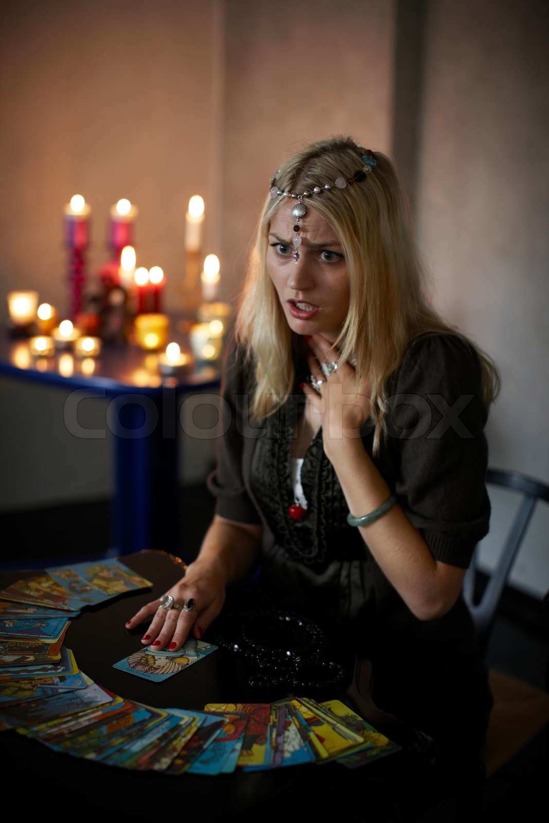 A caucasian female fortune teller and her tarot cards | Stock image ...