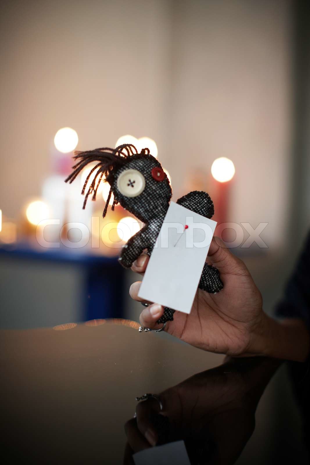A female witch with a voodoo doll doing black magic | Stock image ...