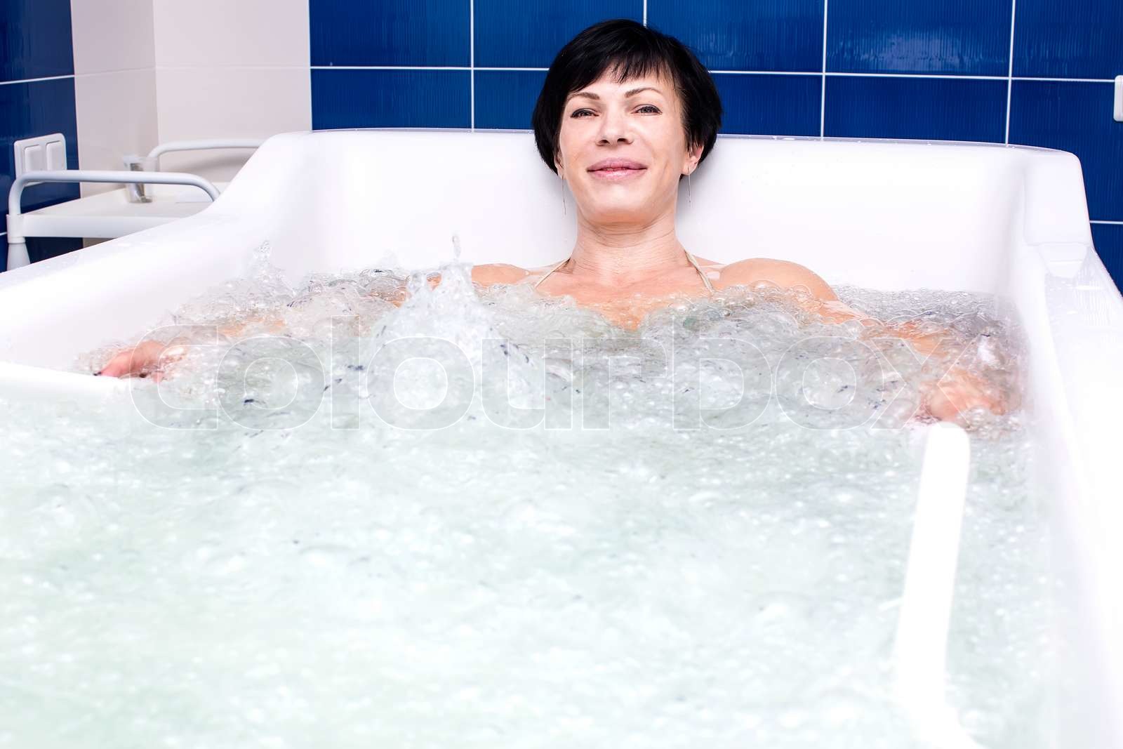 doctor makes a woman a massage at hydrobath | Stock image | Colourbox