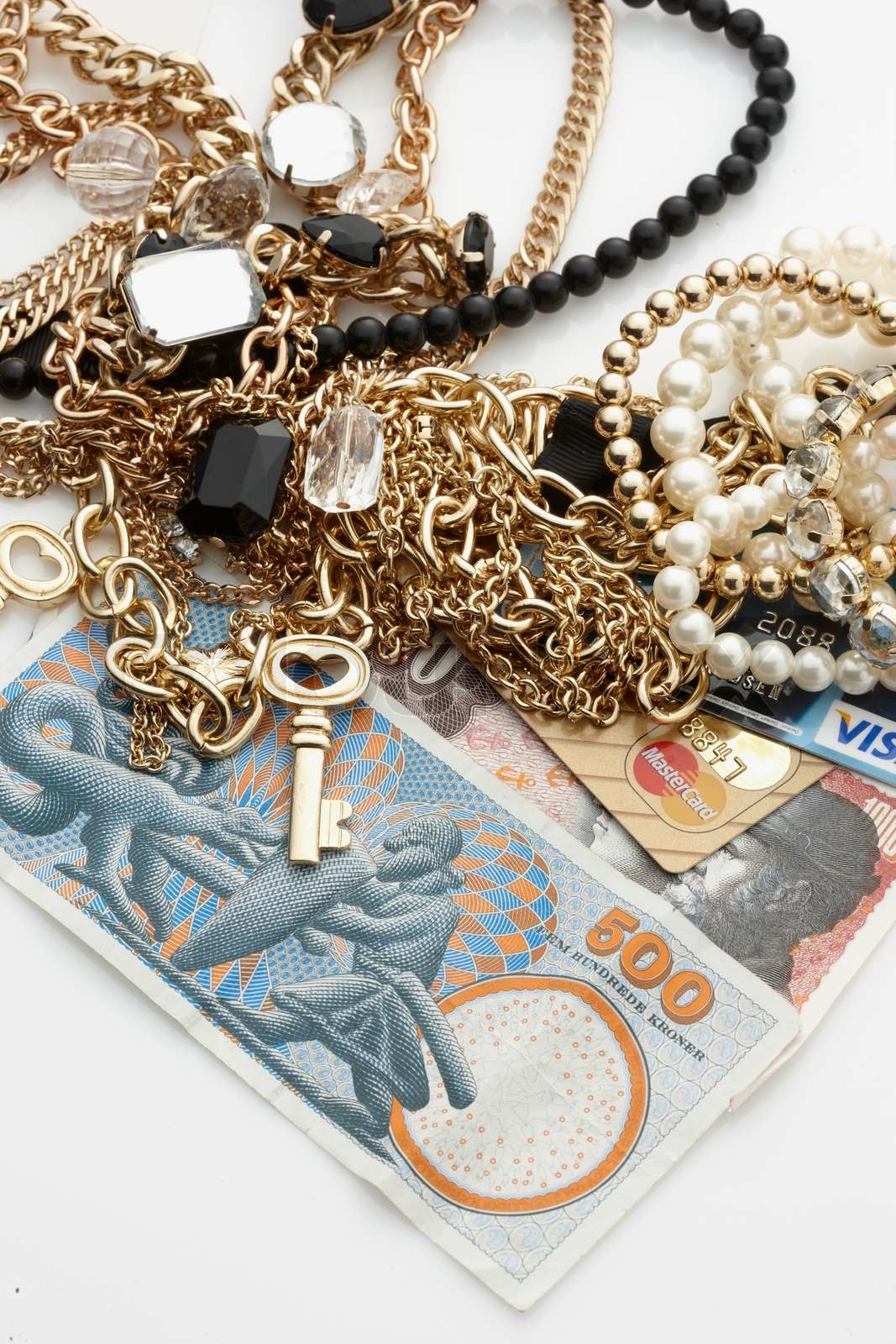 Jewelry collection consisting of gold chain necklace and stack of money ...