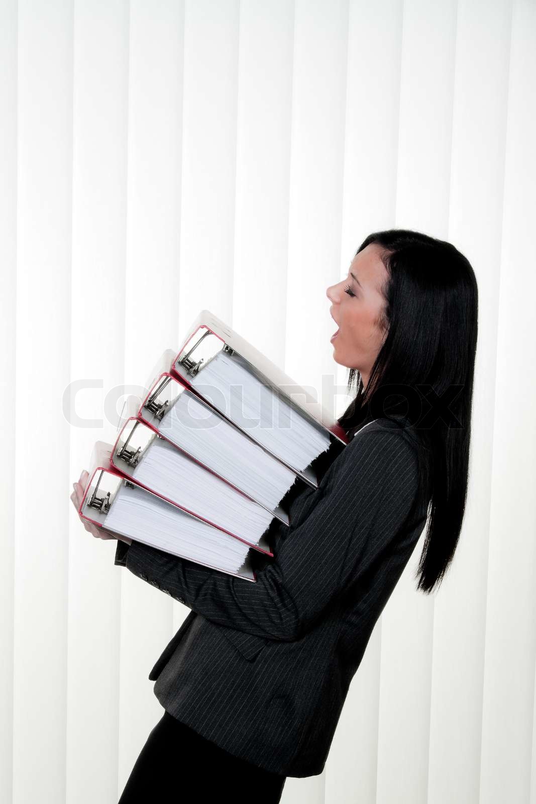 Overburdened women with stress and files in the office. Symbol of ...