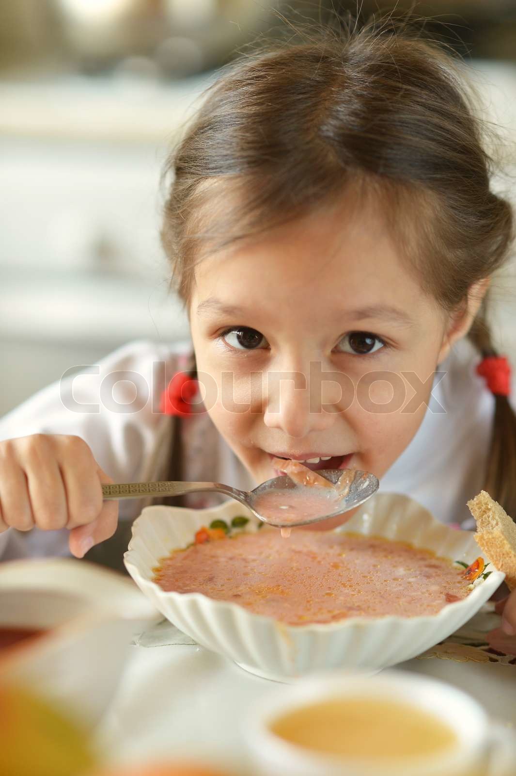 girl eating soup | Stock image | Colourbox