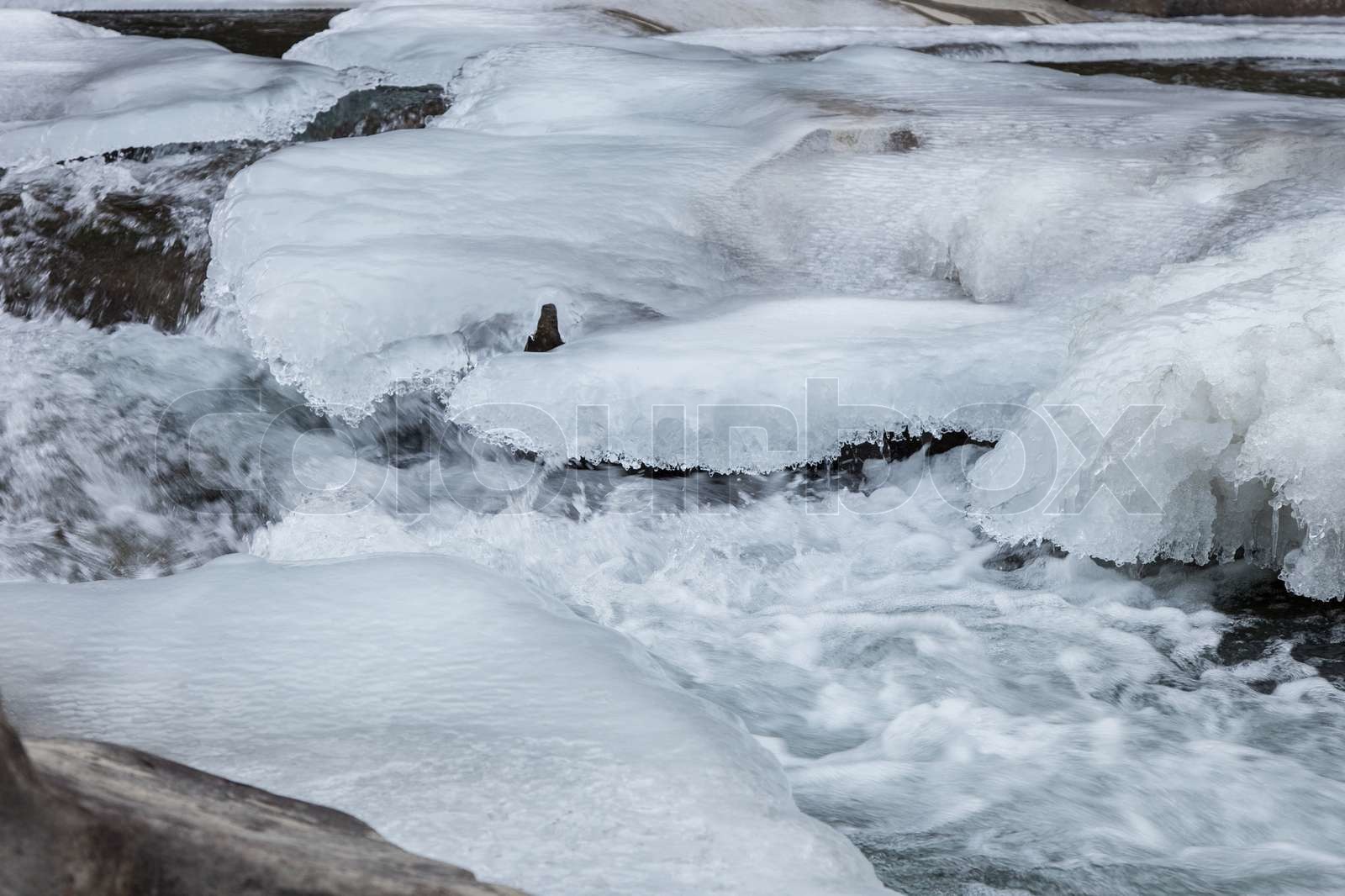 Water stream under ice | Stock image | Colourbox