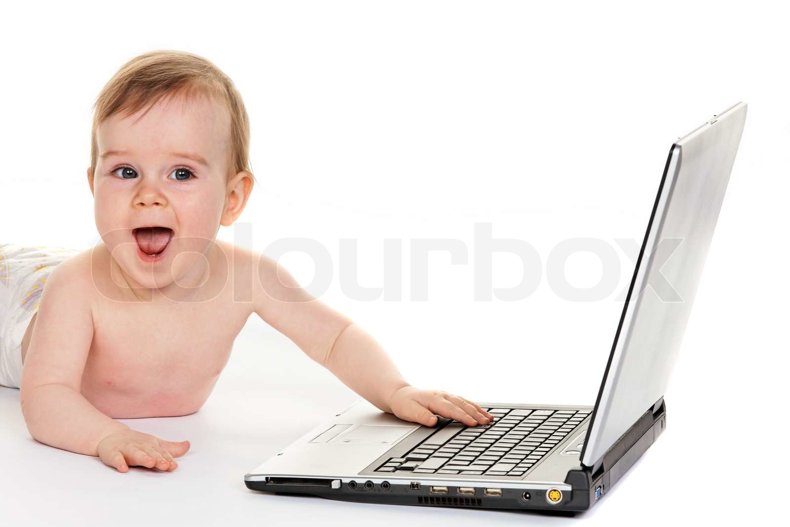 Small child in diapers playing with a laptop computer | Stock image ...