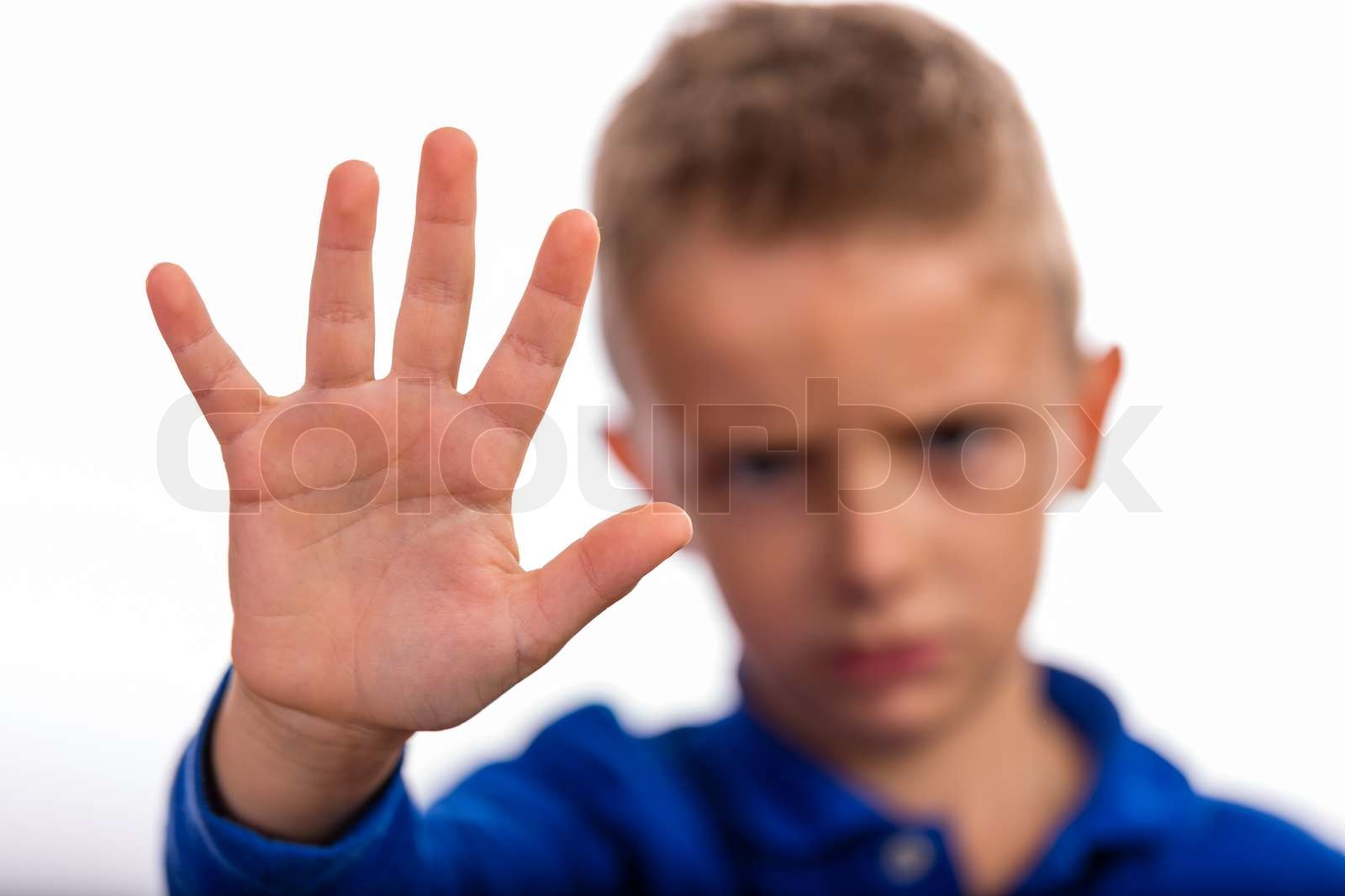 Boy making a stop gesture with his hand | Stock image | Colourbox