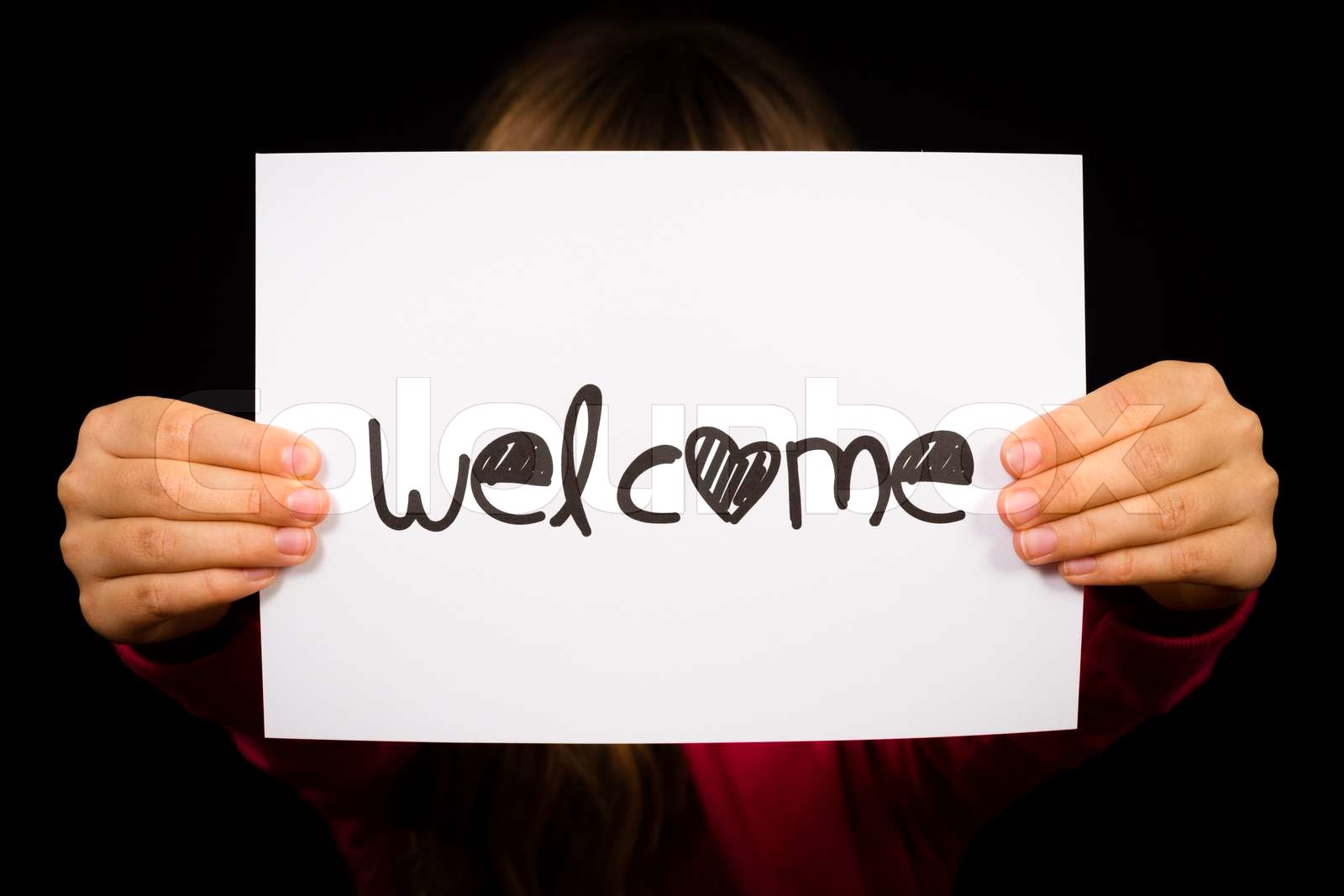 Child holding Welcome sign | Stock image | Colourbox