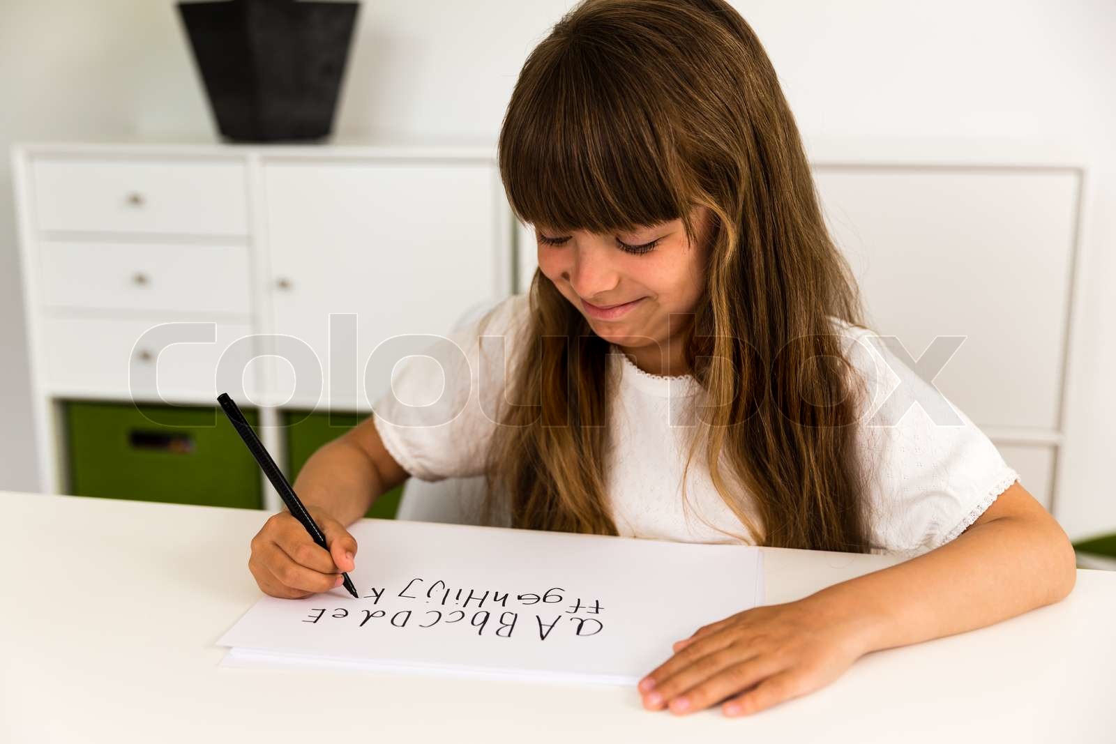 Girl writing the ABC alphabet | Stock image | Colourbox
