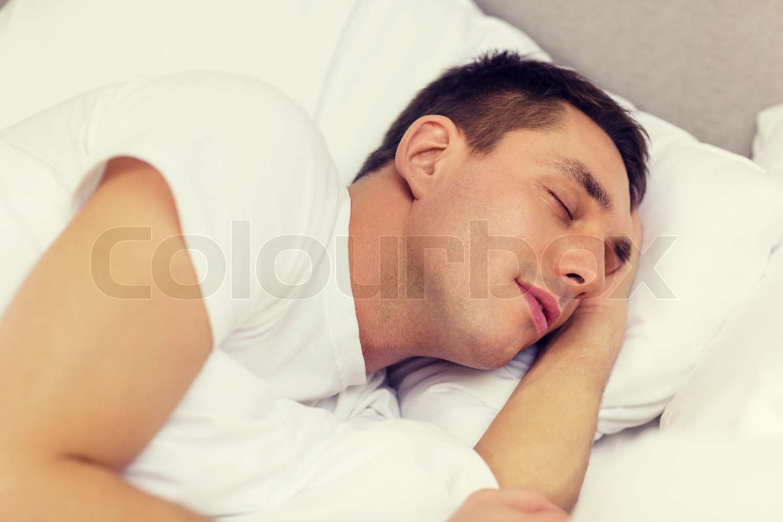 handsome man sleeping in bed | Stock image | Colourbox