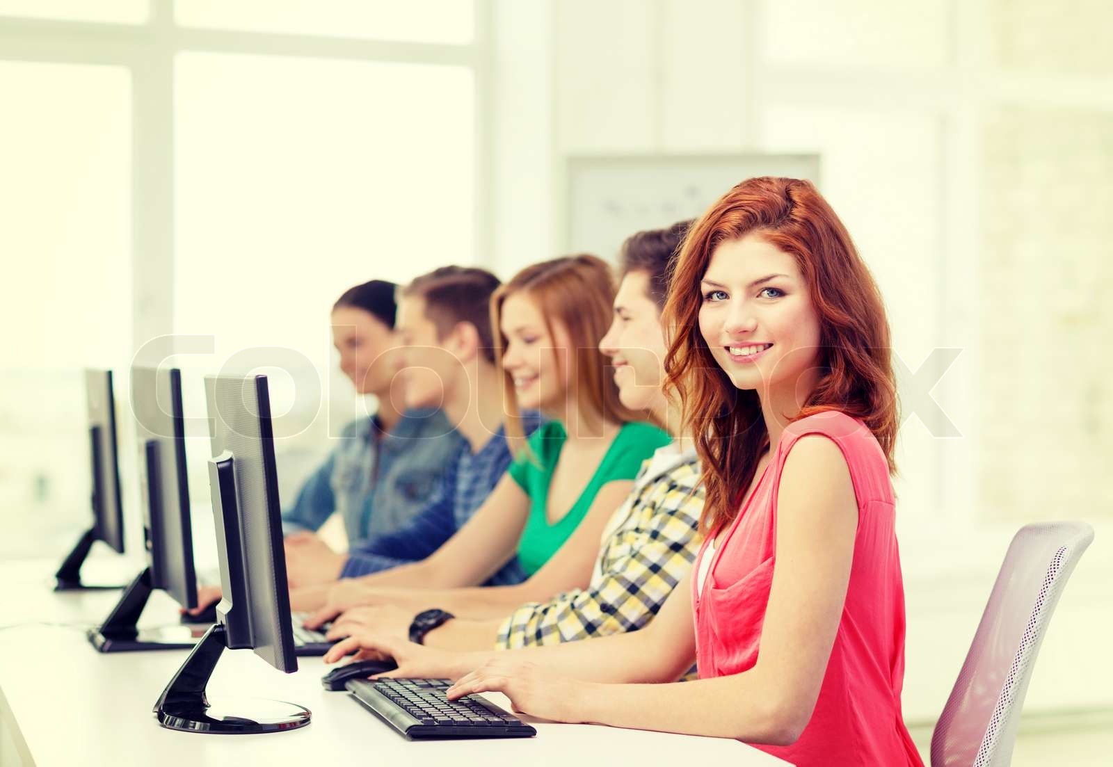 female student with classmates in computer class | Stock image | Colourbox