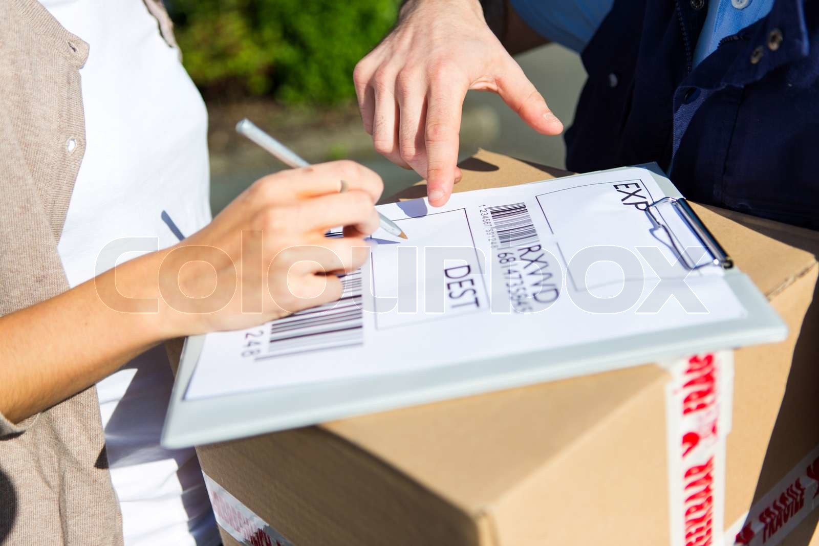 Details of a customer signing delivery note | Stock image | Colourbox