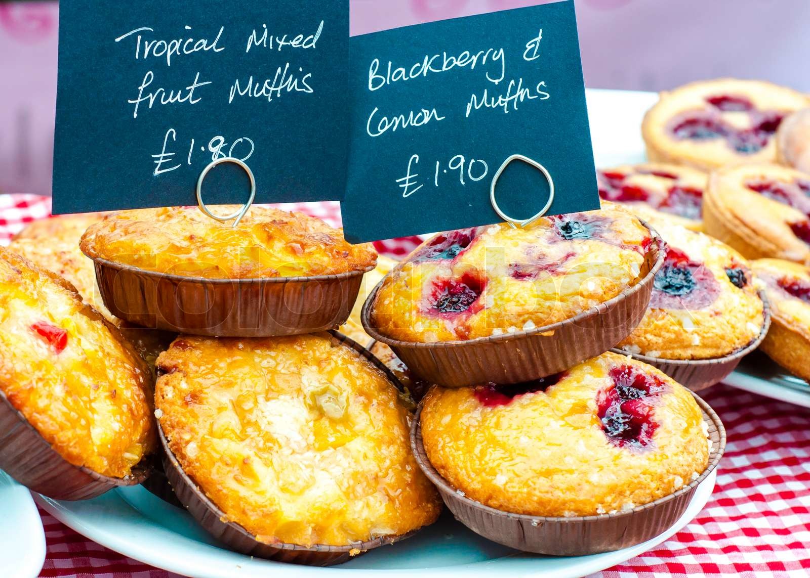 Delicious round raspberry tarts in British market | Stock image | Colourbox