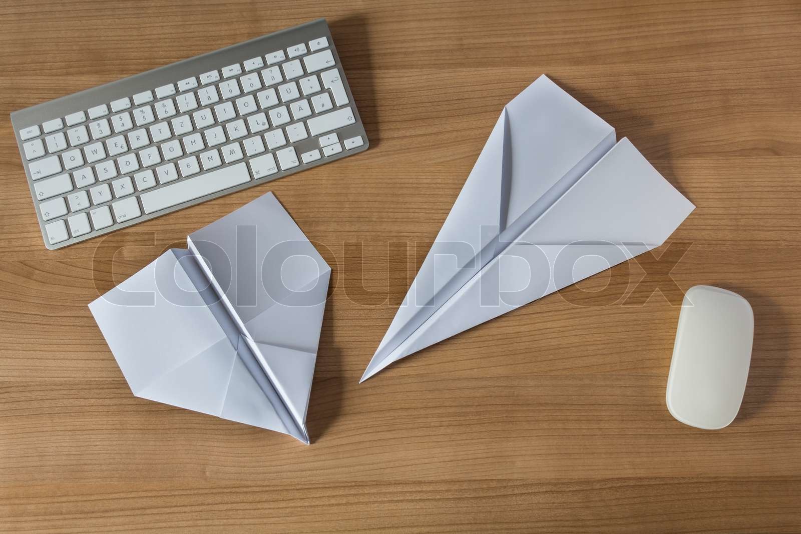 Paper Plane on an office desk | Stock image | Colourbox