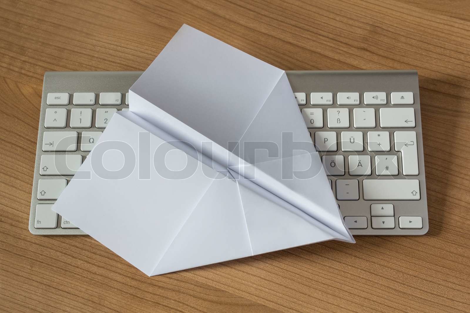 Paper Plane on an office desk | Stock image | Colourbox