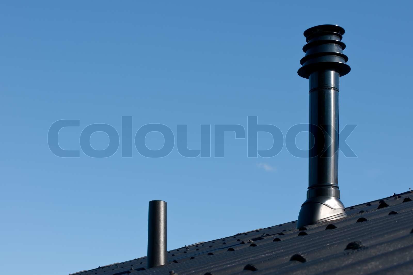 Roof with ventilation pipe and flue terminal from natural gas boiler ...