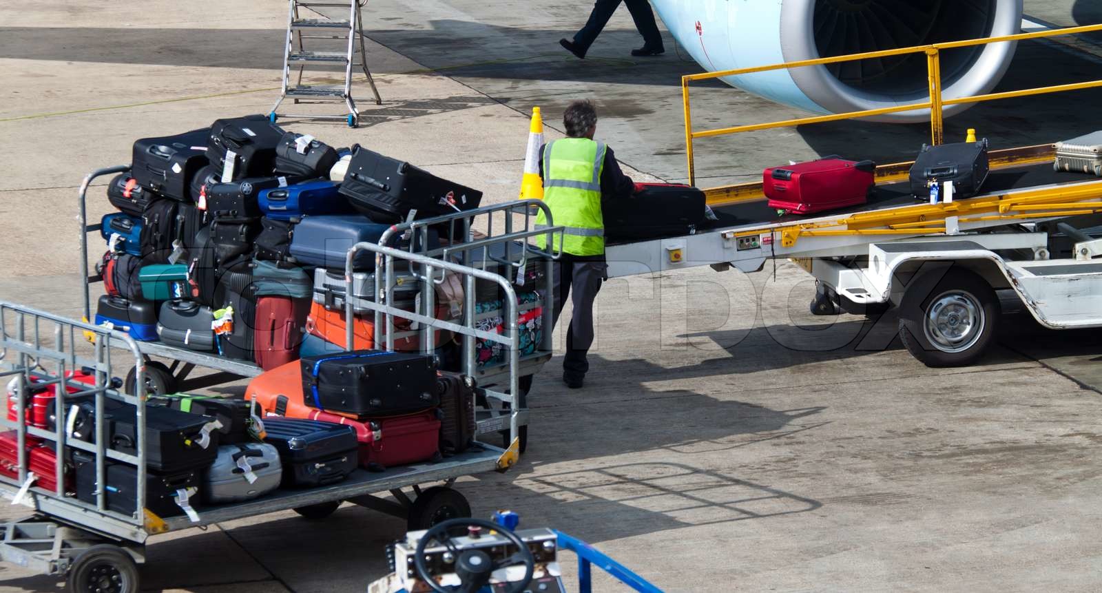 Bags and luggage being loaded onto an airplane. | Stock image | Colourbox