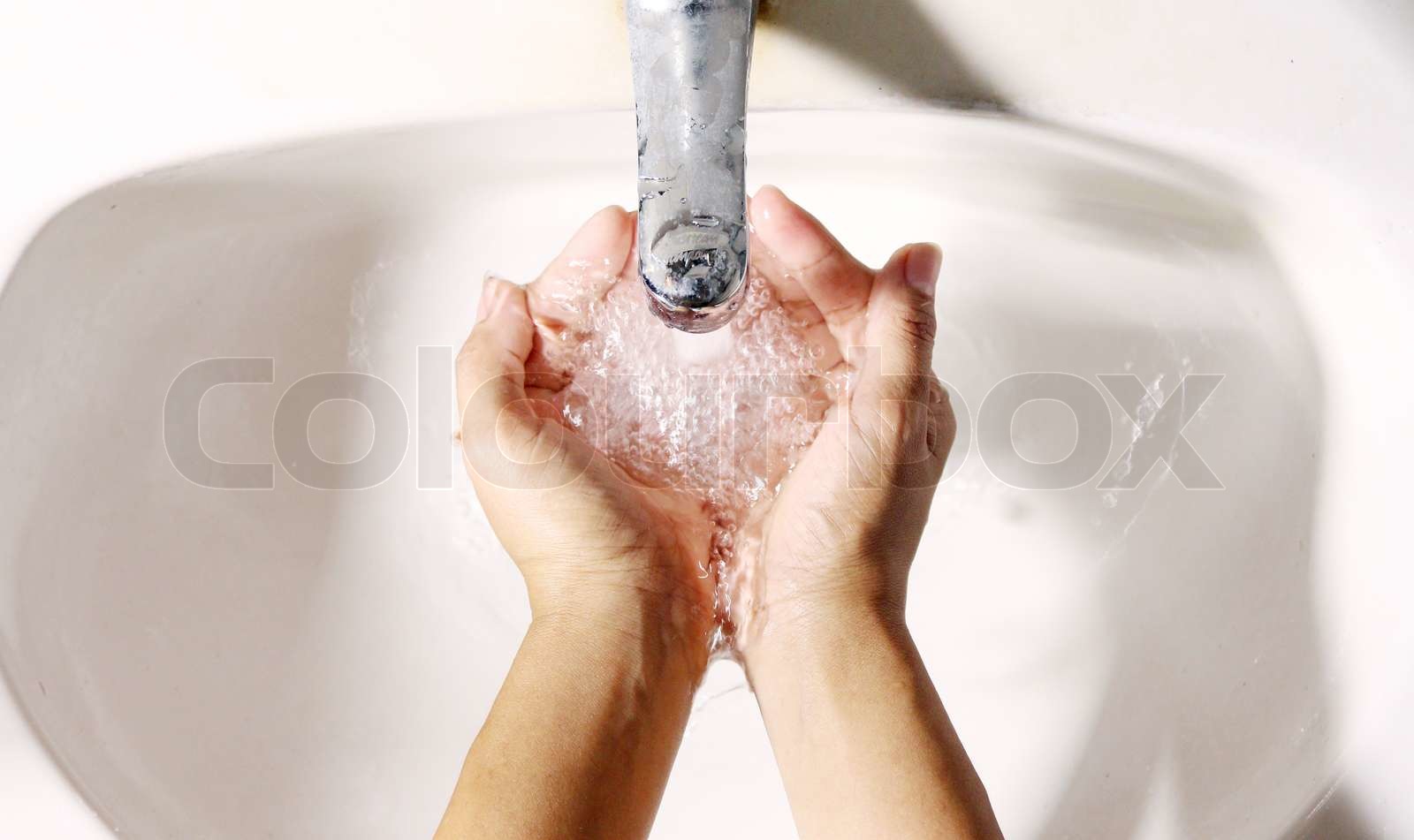 Woman washing, cleaning hand by water from trap | Stock image | Colourbox