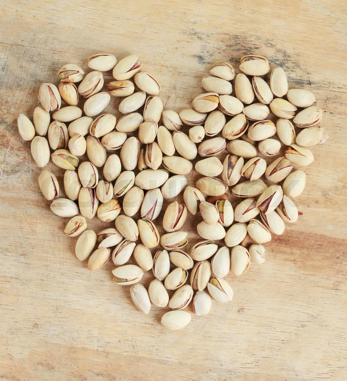 Pistachio nuts in heart shape | Stock image | Colourbox