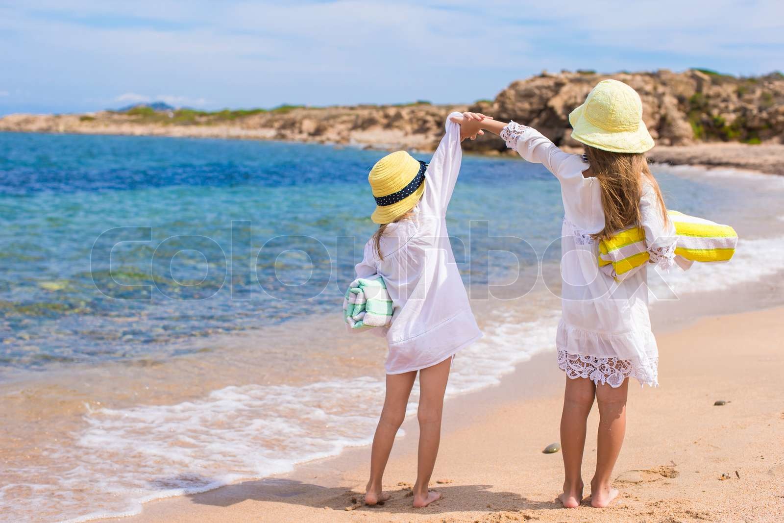 Adorable cute girls have fun on white beach during vacation | Stock ...