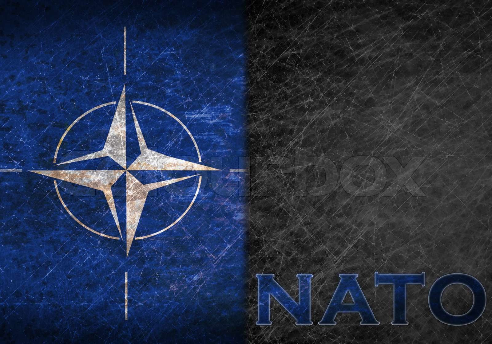 Old rusty metal sign with a NATO flag | Stock image | Colourbox