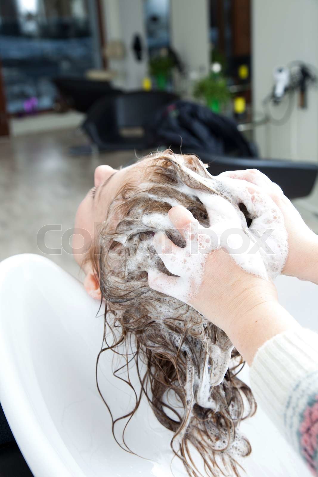 A woman getting her hair washed in a hair salon | Stock image | Colourbox