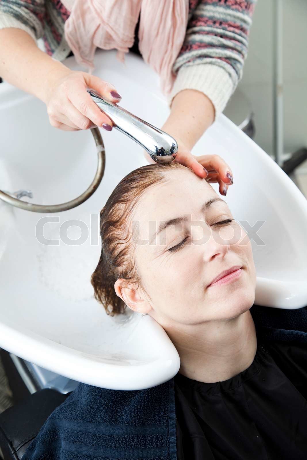 A woman getting her hair washed in a hair salon | Stock image | Colourbox