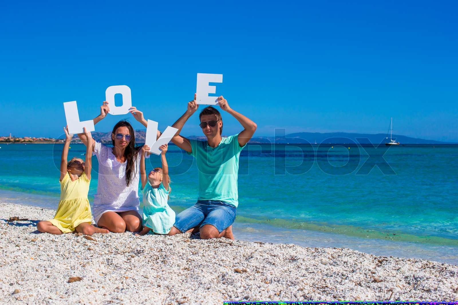 Young happy family with two kids on tropical vacation | Stock image ...