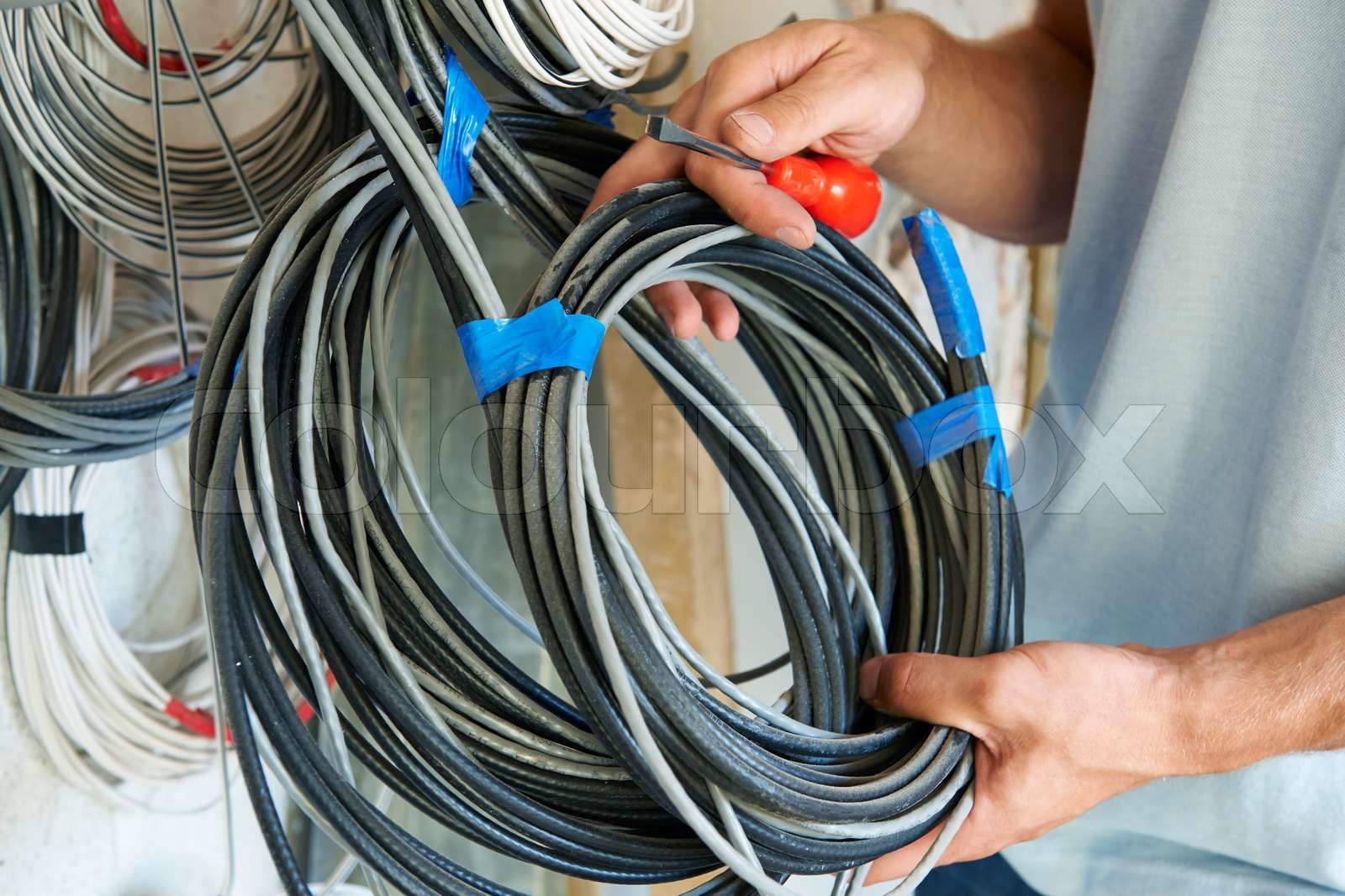 Close Up Of Electrician Fitting Wiring On Construction Site | Stock ...