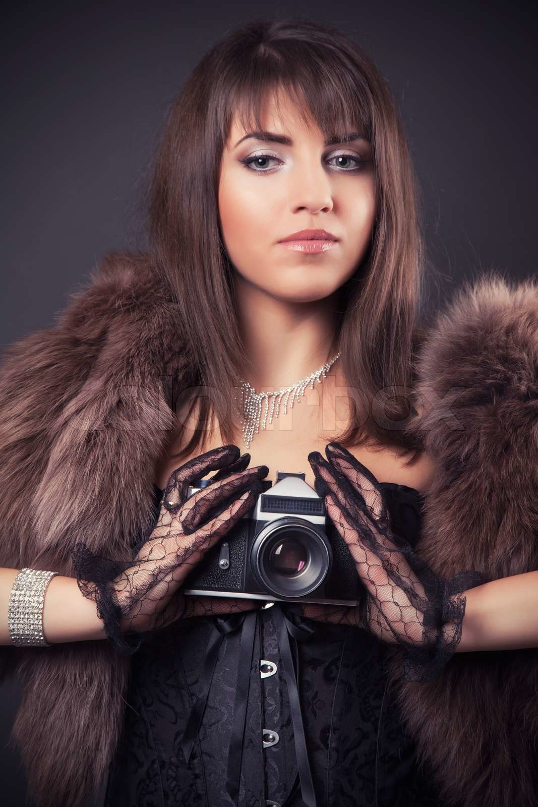 portrait of beautiful young retro woman holding vintage camera | Stock ...