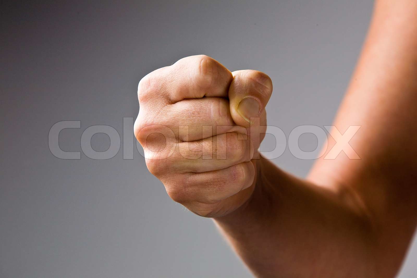 a clenched fist with the threat of strike | Stock image | Colourbox