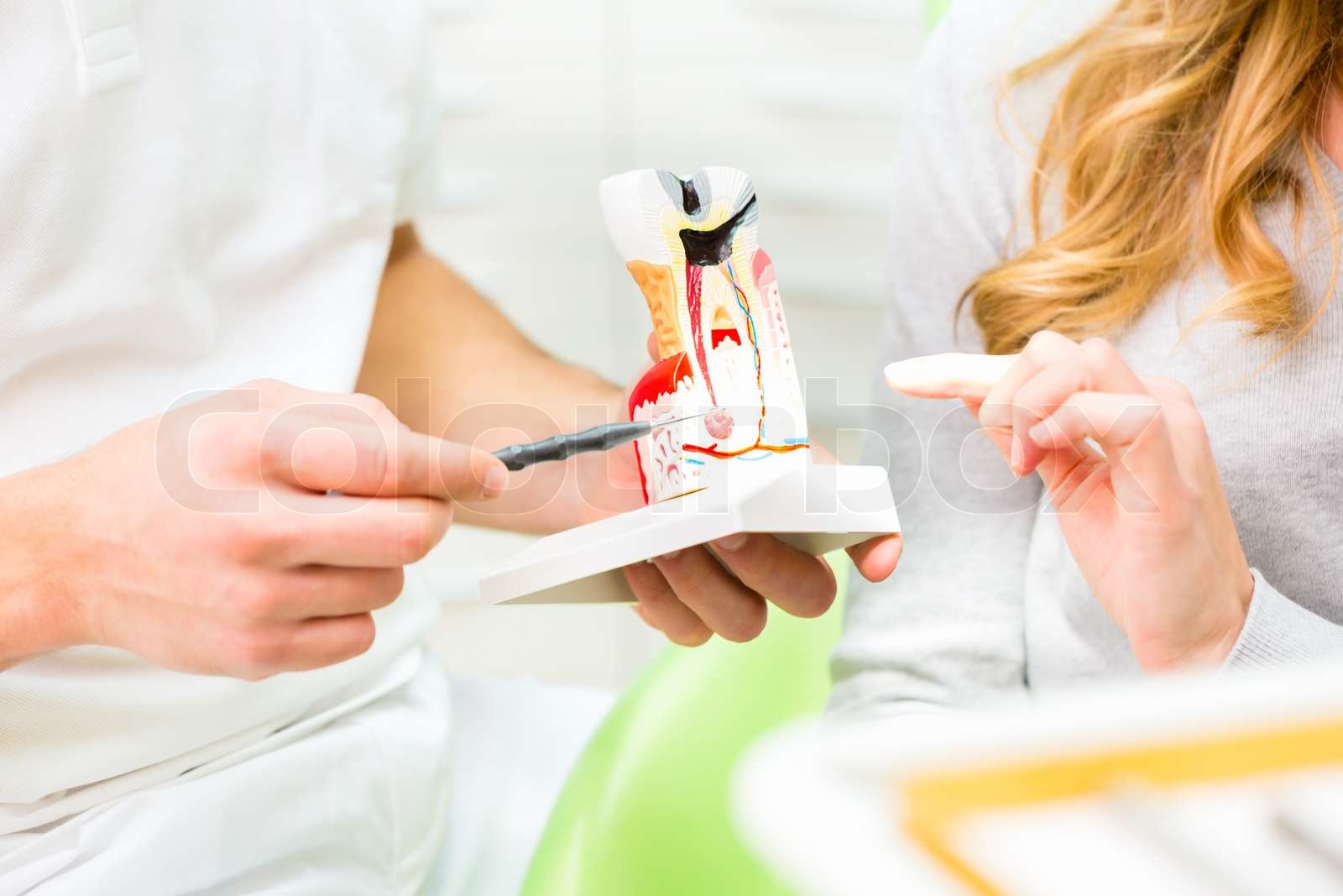 Dentist explaining patient therapy | Stock image | Colourbox