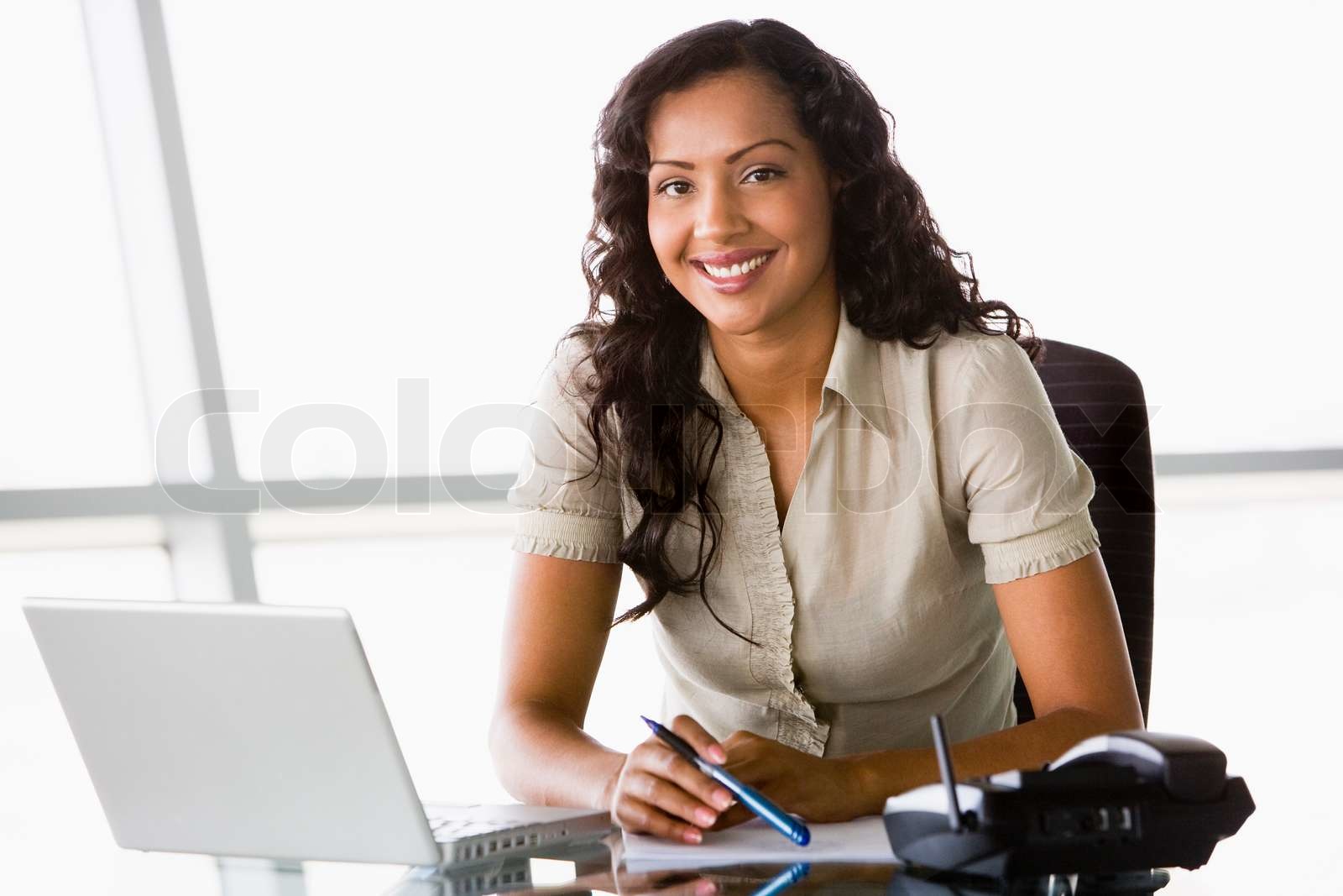Businesswoman working at desk in office | Stock image | Colourbox