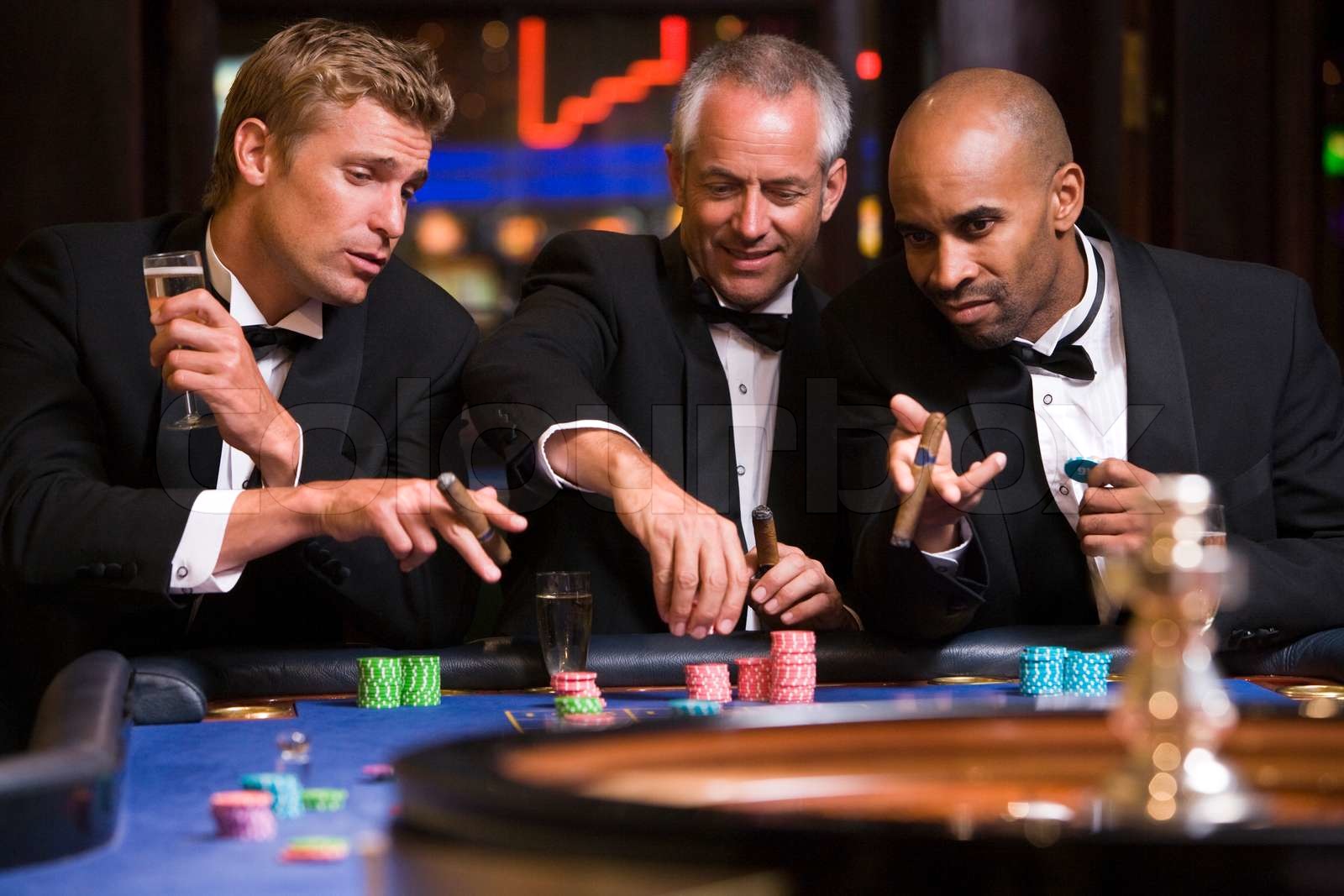 Group of men gambling at roulette table in casino | Stock image | Colourbox