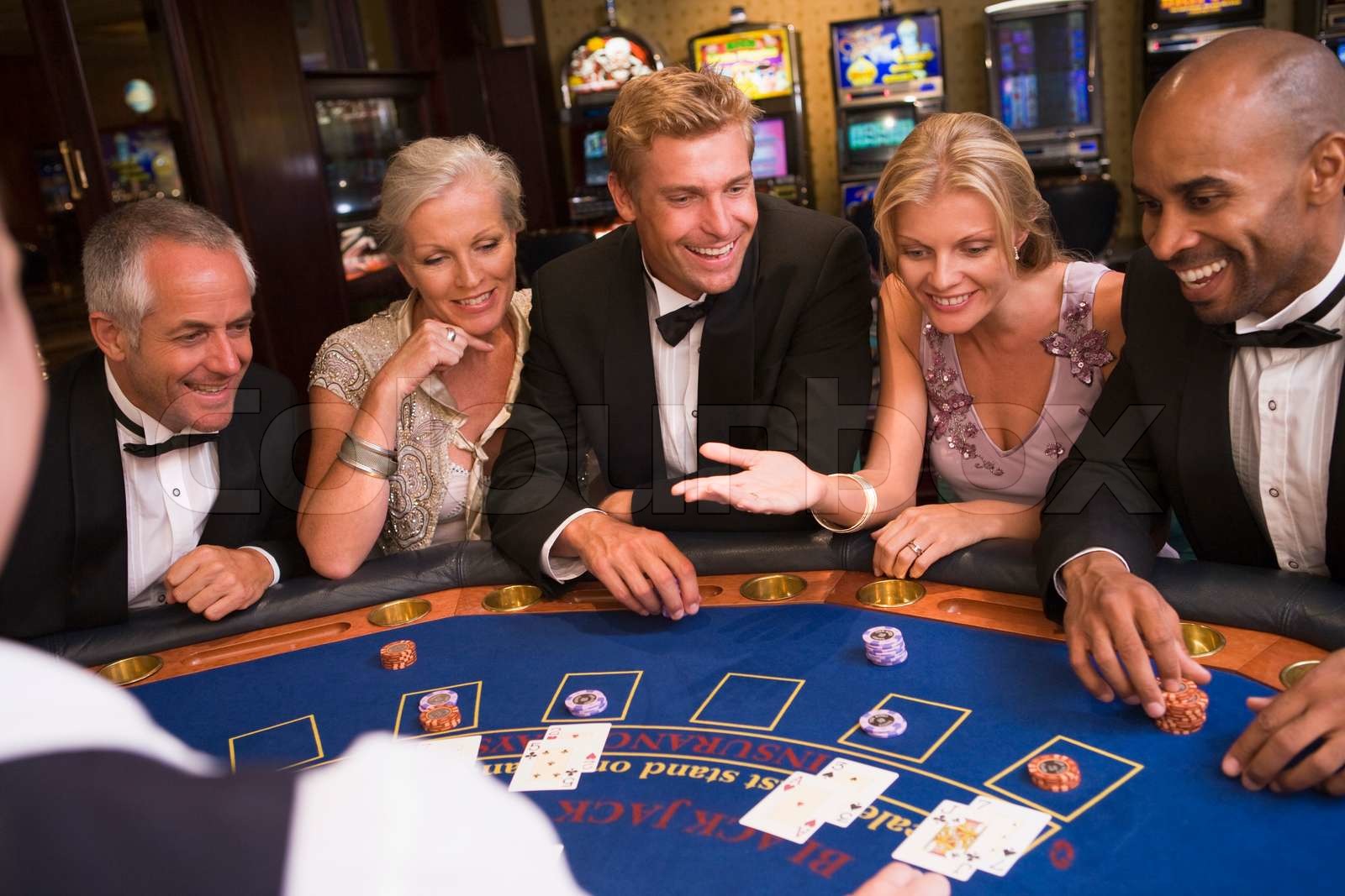 Five people sitting around blackjack table in casino | Stock image ...