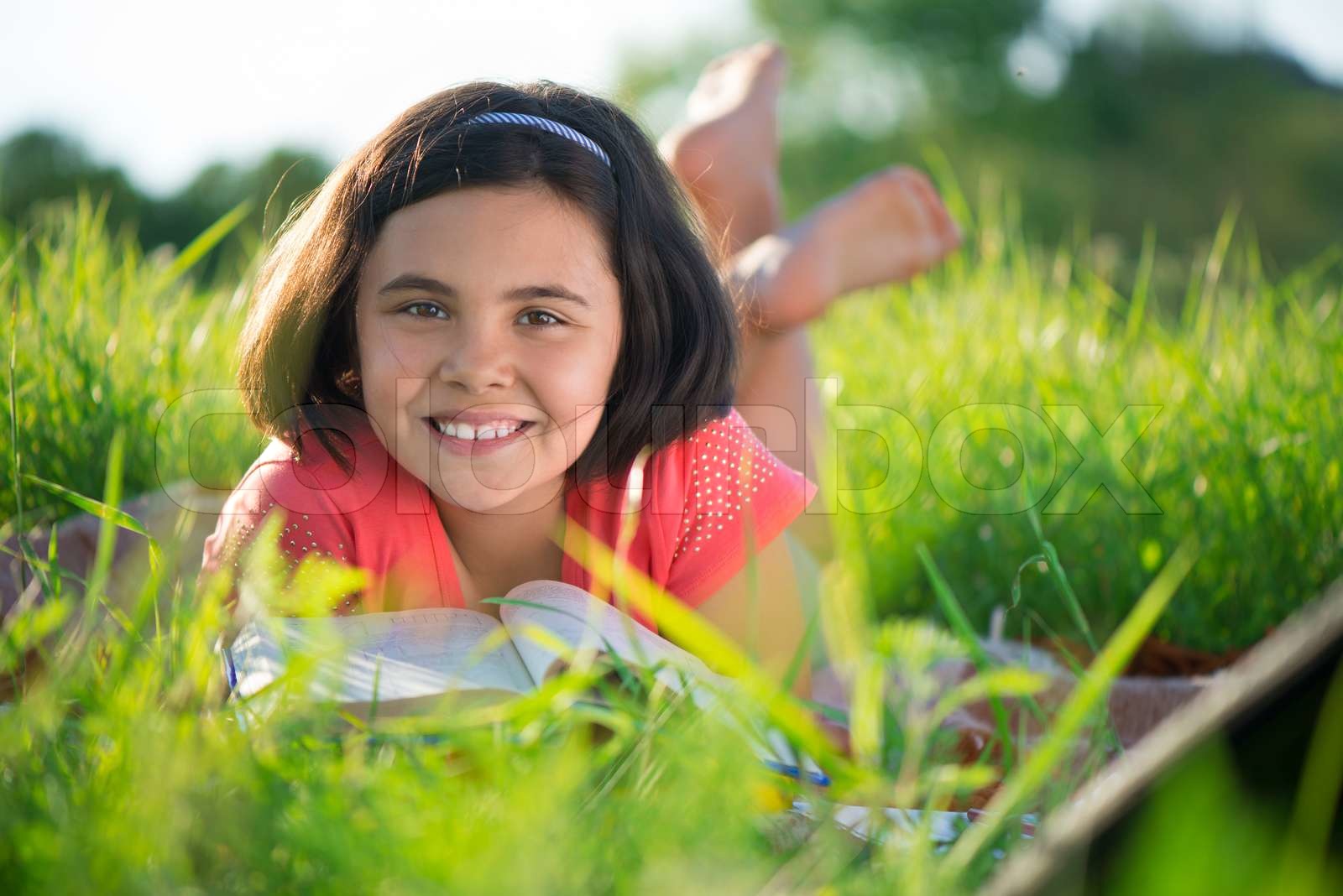 Happy child studying on nature | Stock image | Colourbox